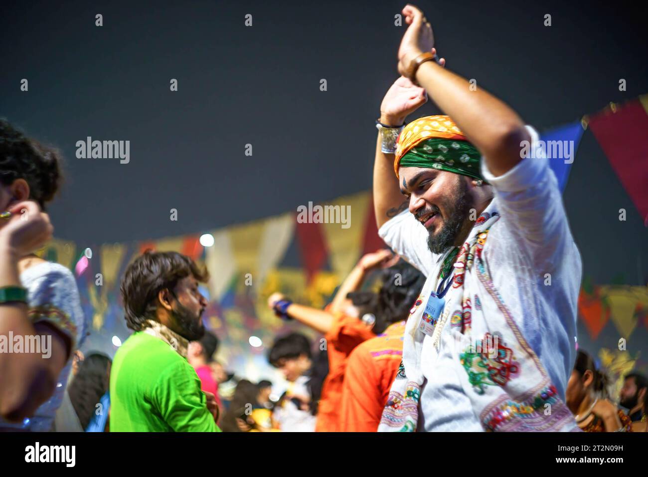 A man in traditional Indian clothes seen dancing traditional Garba ...