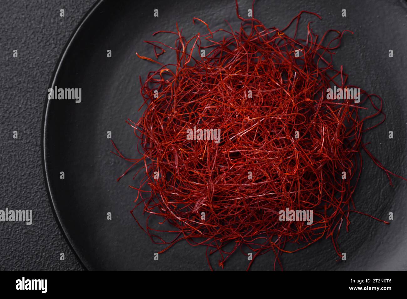 Red thin hot chili threads on a dark background. For decorating Asian ...