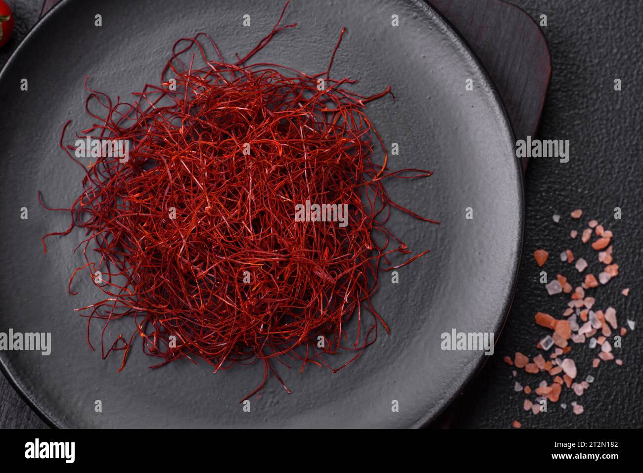 Red thin hot chili threads on a dark background. For decorating Asian ...