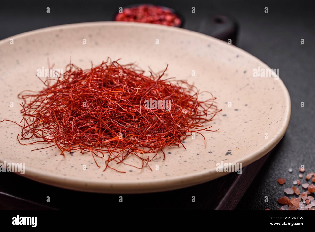 Red thin hot chili threads on a dark background. For decorating Asian ...