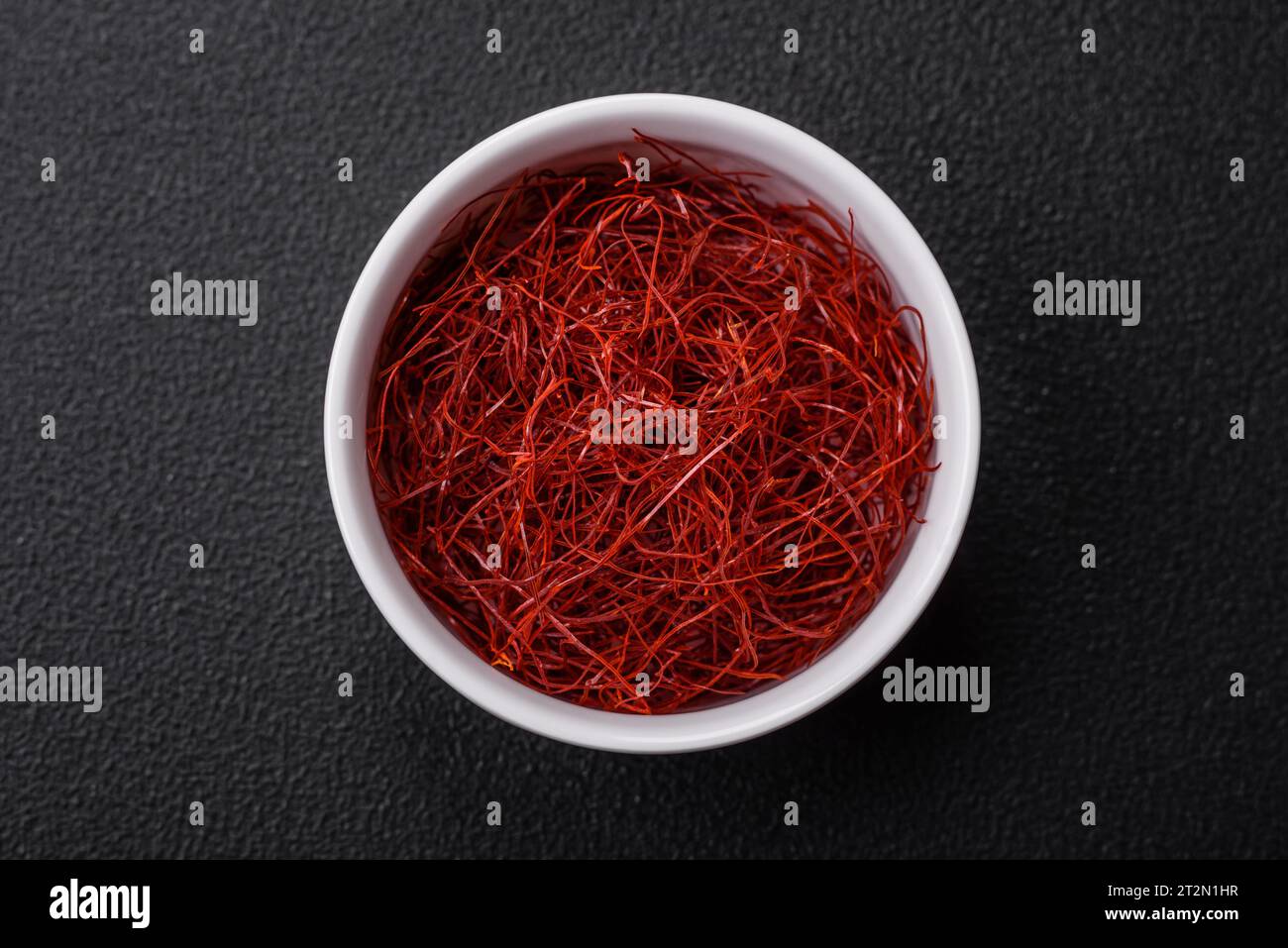Red thin hot chili threads on a dark background. For decorating Asian ...