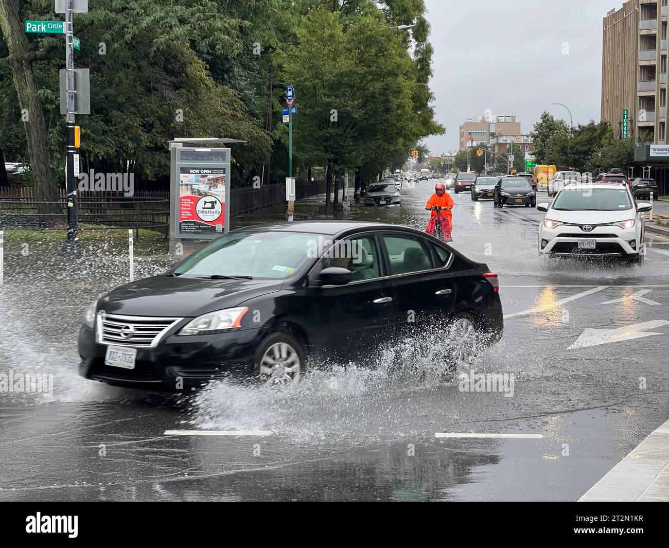 Cars "float" through flooded streets around Prospect Park after heavy ...