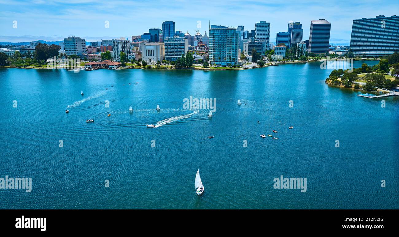 Variety of small colorful boats on gorgeous blue Lake Merritt with ...