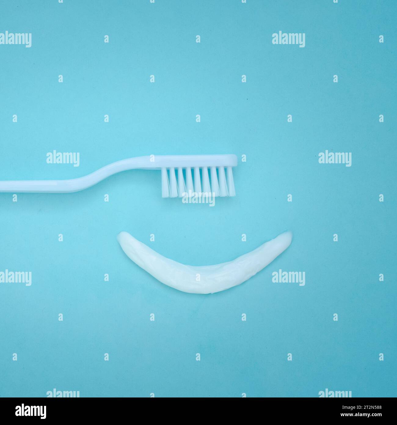 Smiley face created from paste with white Toothbrush. Care for oral and ...