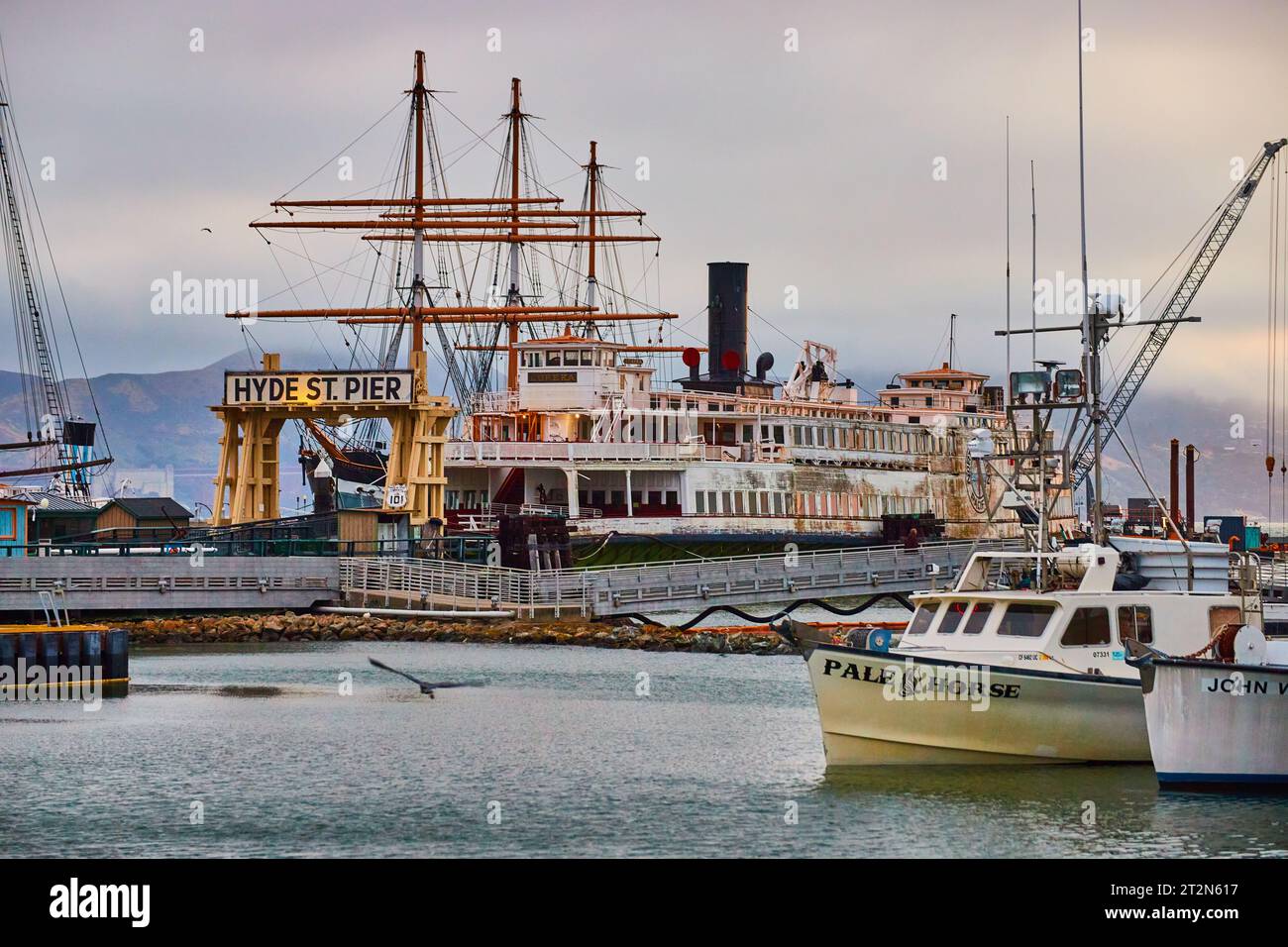 Pale Horse and John W ships at Hyde St Pier with seagull over water and ...