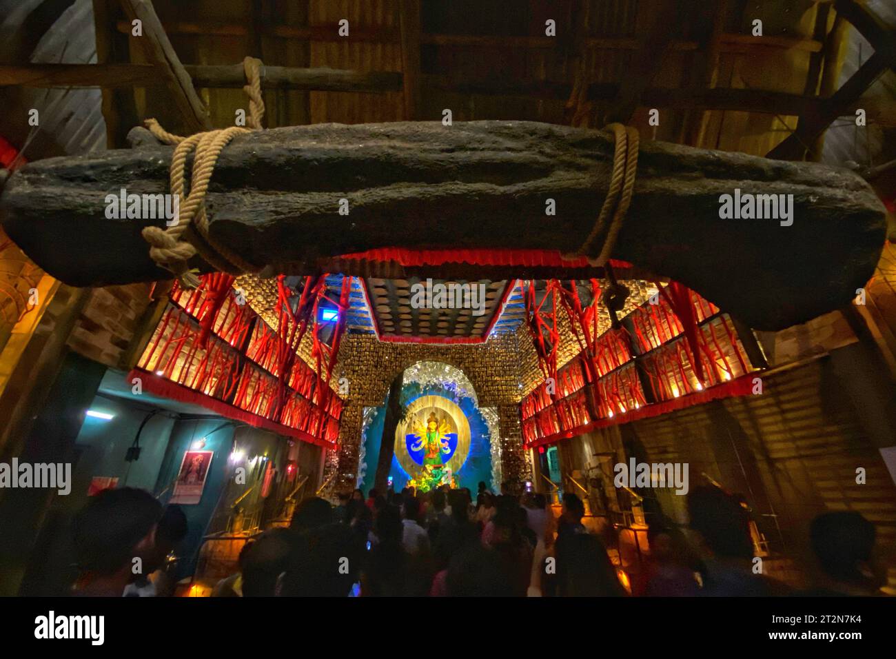 Visitors take photos of an idol of the Hindu Goddess Durga at the ...