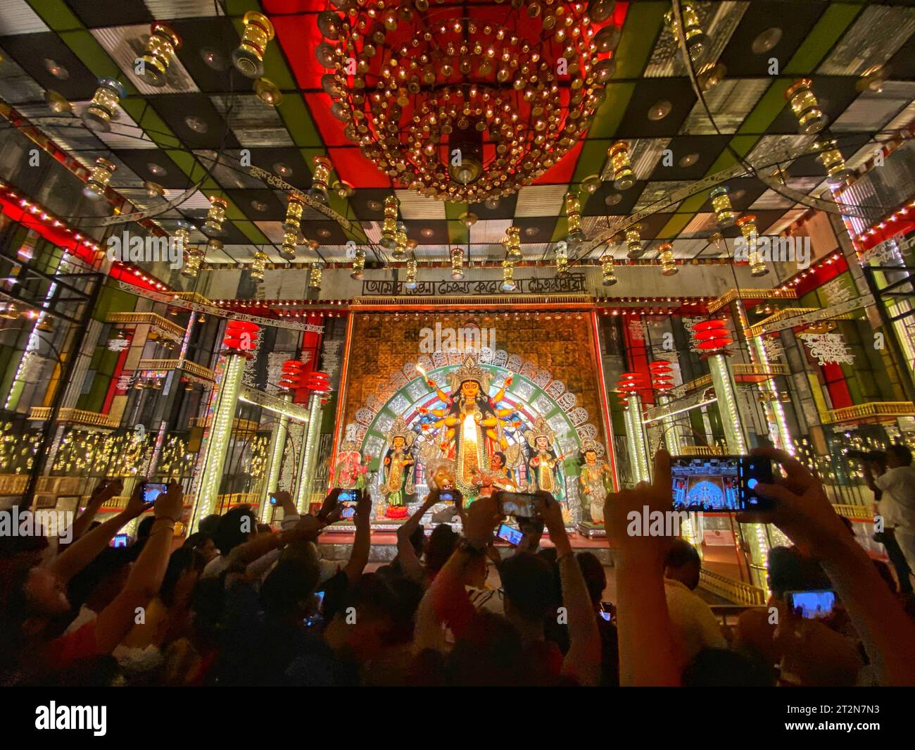 Visitors take photos of an idol of the Hindu Goddess Durga at the ...