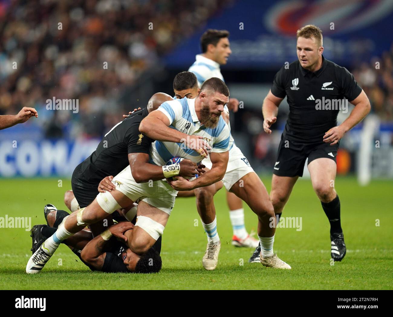 Argentina's Marcos Kremer tackled by New Zealand's Mark Telea (left ...