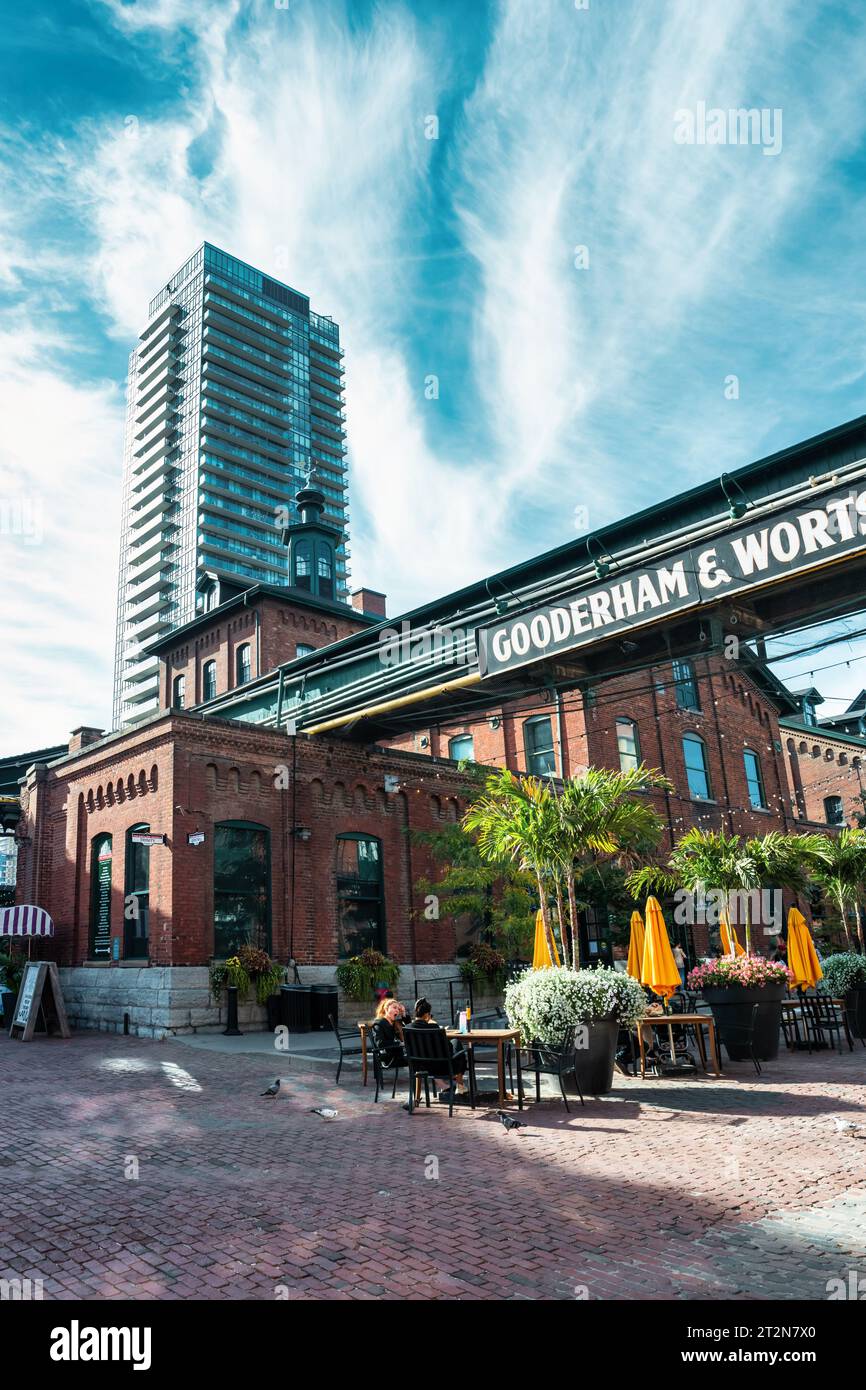 People relax on a patio in the Distillery District in Toronto, Ontario ...