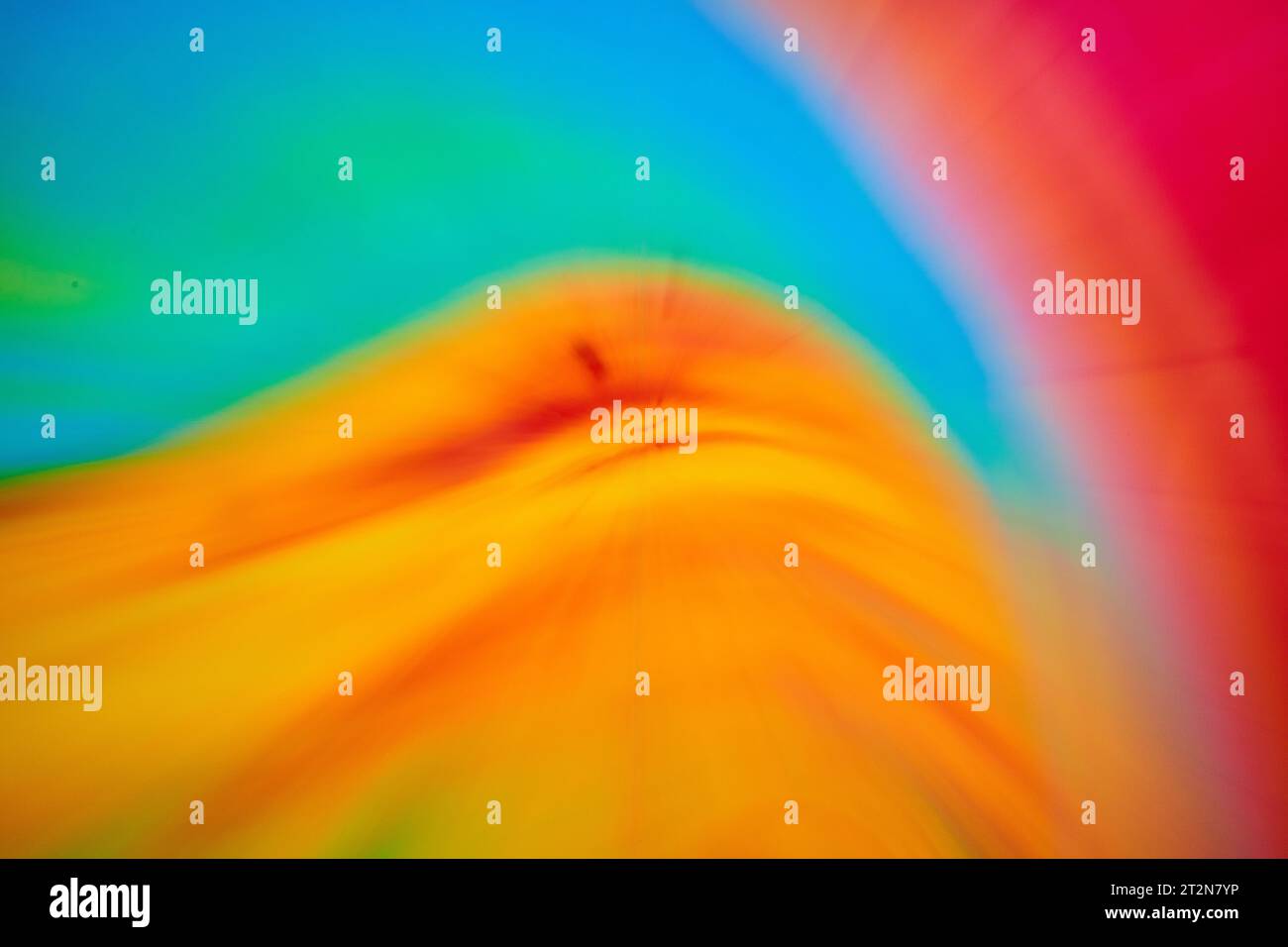 Abstract mound of gold under teal blue wave with red sky background ...