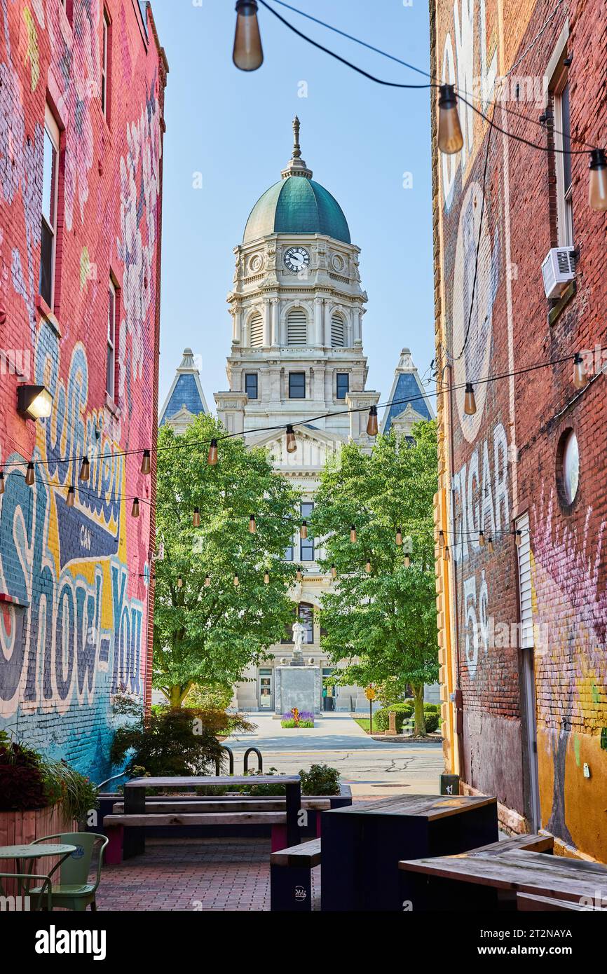 Fancy alley with benches and chairs and wall art murals leading to ...