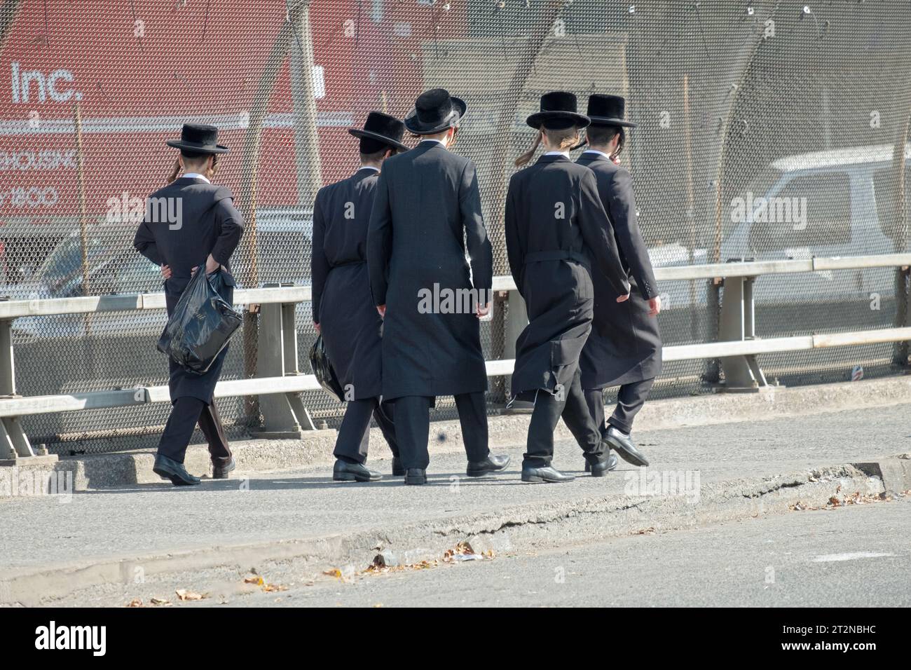 Five orthodox Jewish young men cross the BQE overpass on teir way home ...