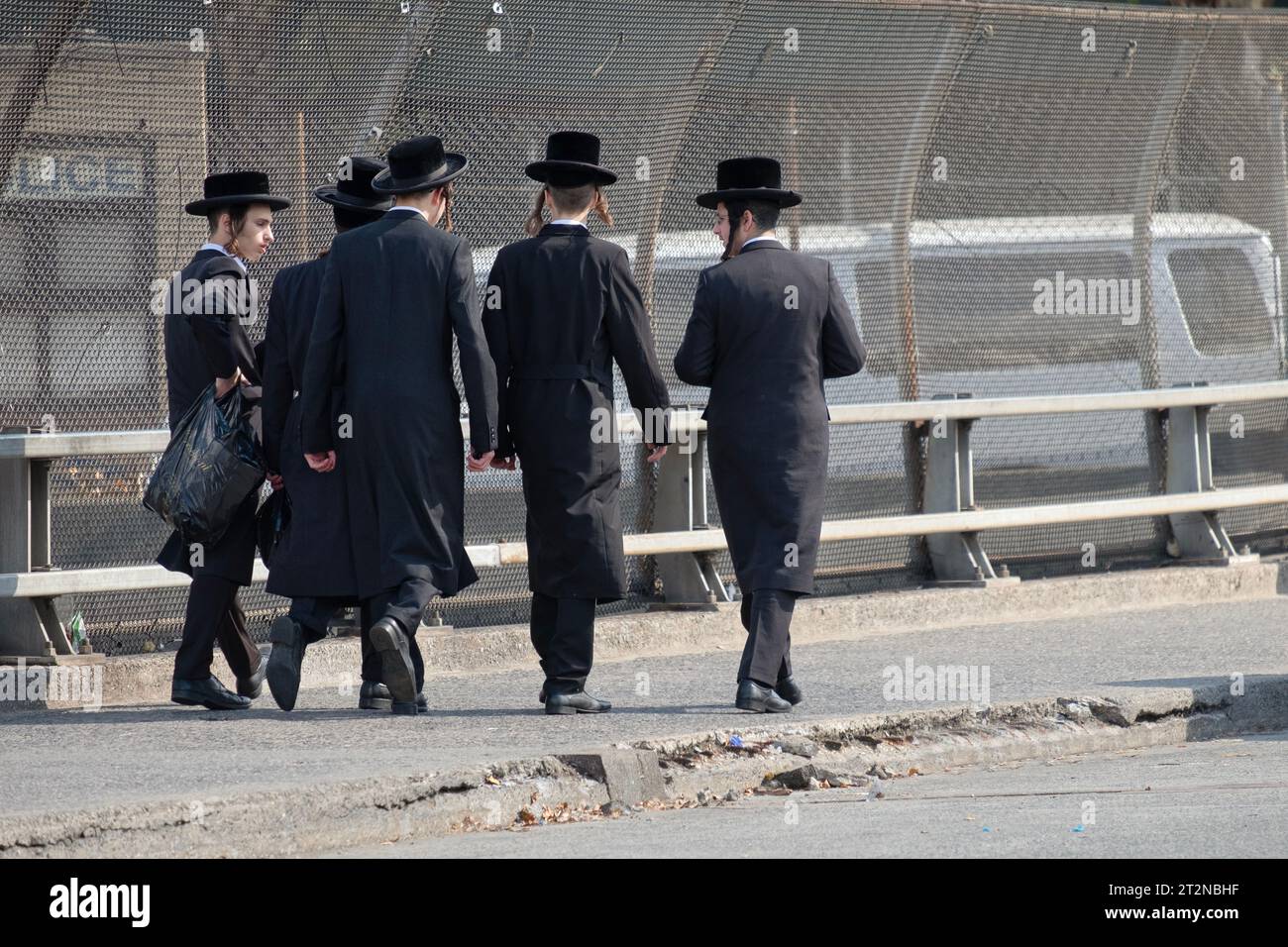 Five orthodox Jewish young men cross the BQE overpass on teir way home ...