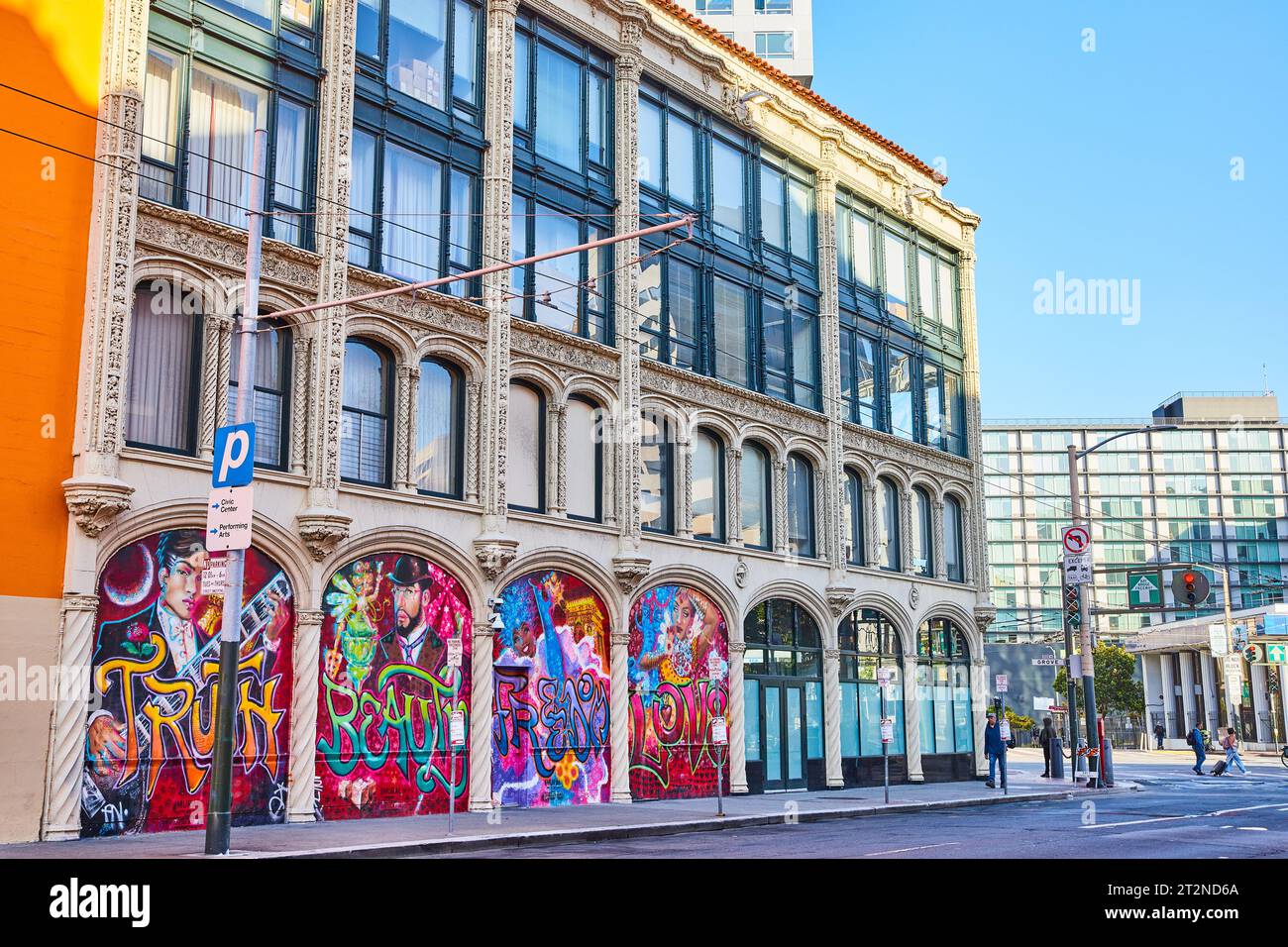 Building archways covered in wall mural graffiti with Truth and love ...