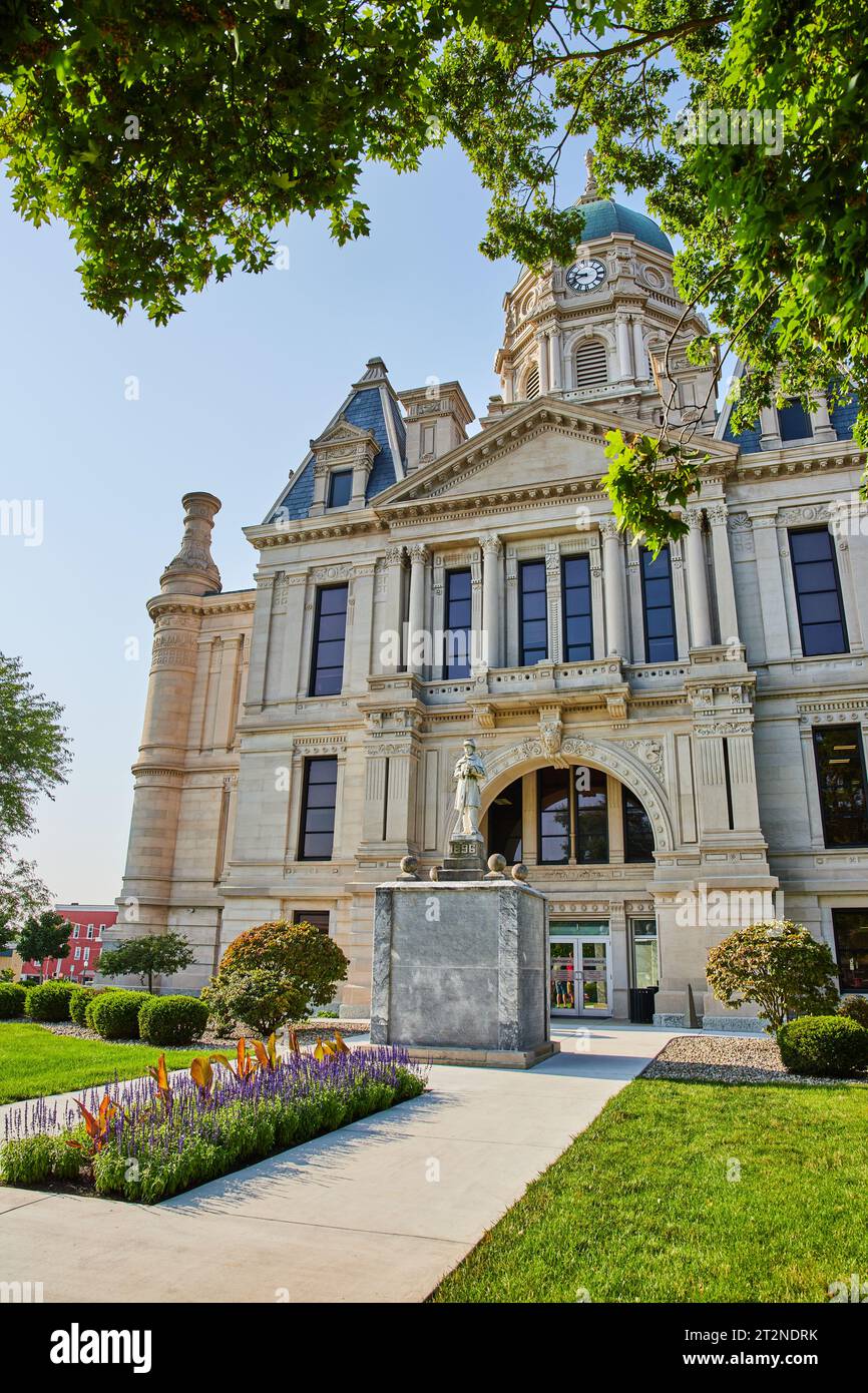 Side view of front entrance with statue and flowers leading into ...