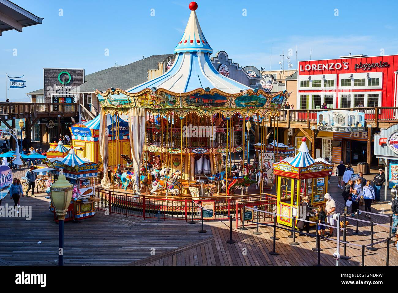 Animal carousel on Pier 39 with people lining up in line for ride ...