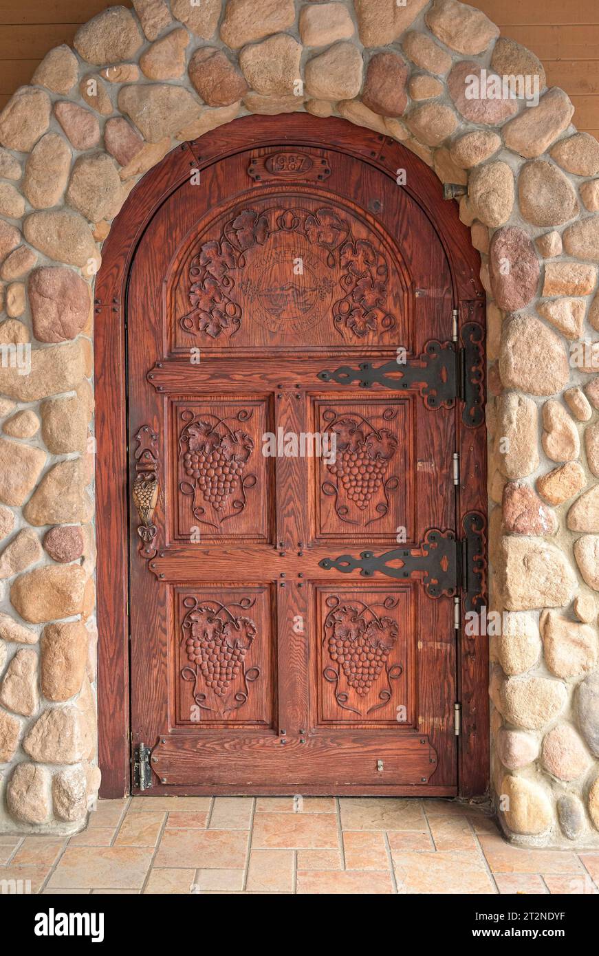 Ornate carved wood door with grape motif, Summerhill Pyramid Winery ...