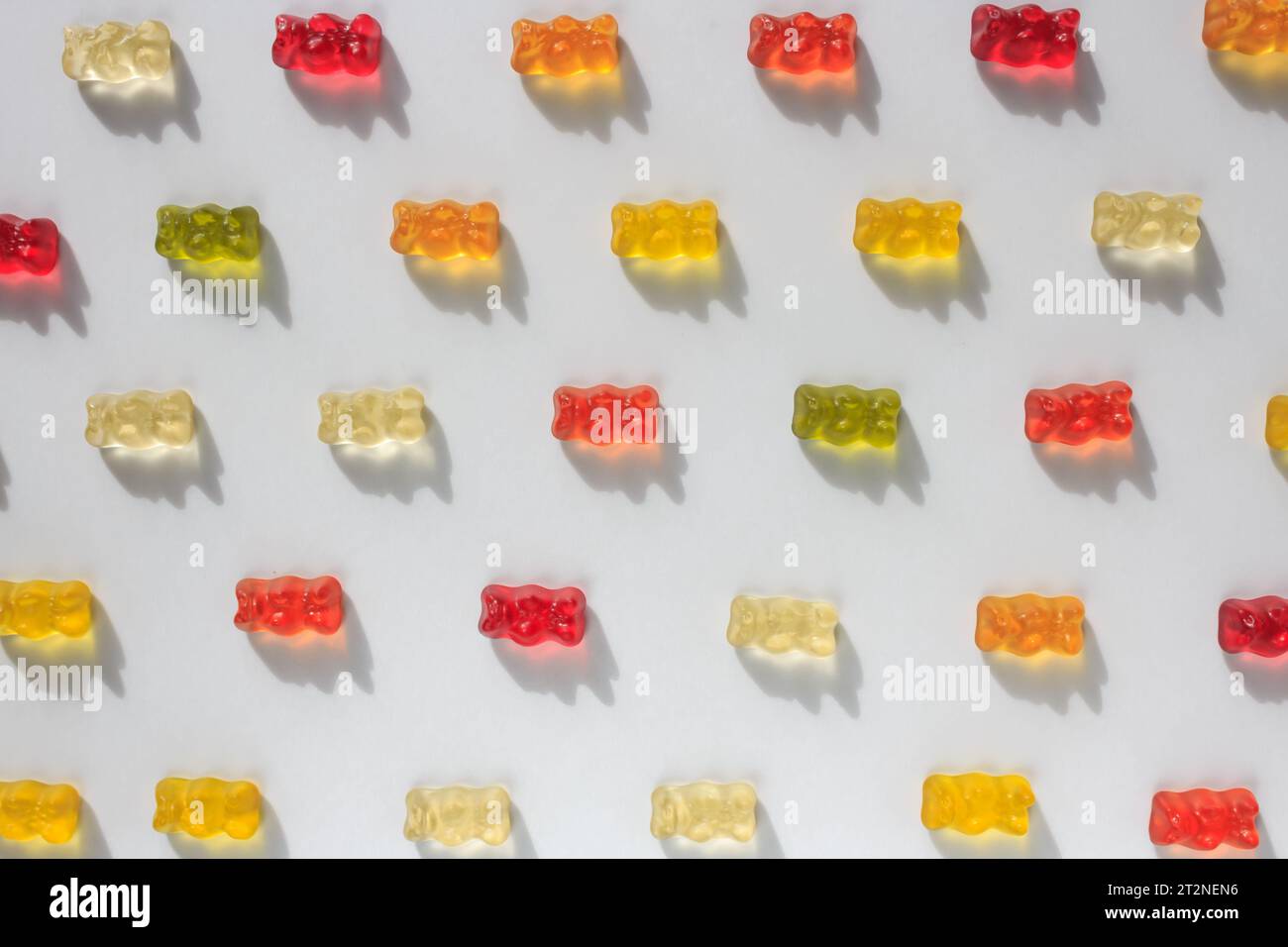Jelly multi-colored bright candies on a white background, laid out in ...
