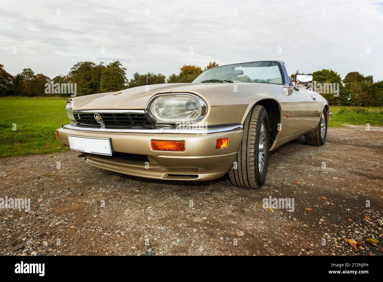 Low viewpoint of the front offside wing of a convertible Jaguar XJS ...