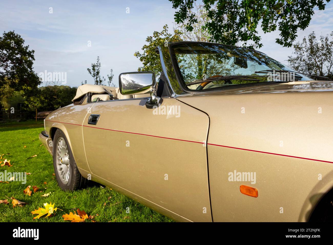 Close up of side of a convertible Jaguar XJS with top down in a country ...