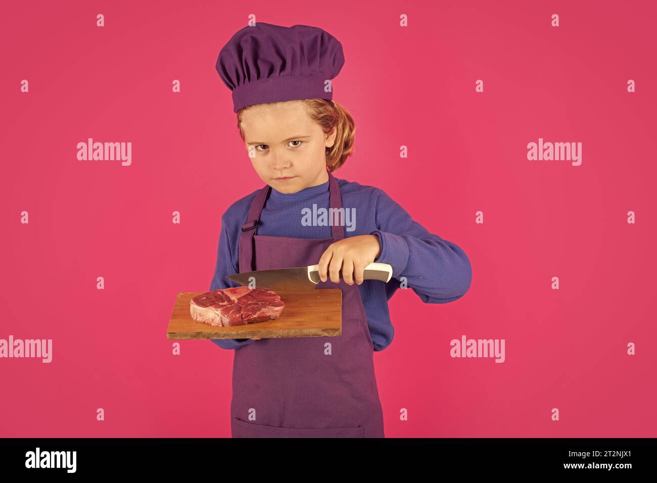 Child cook hold cutting board with meat beef steak and knife. Chef ...