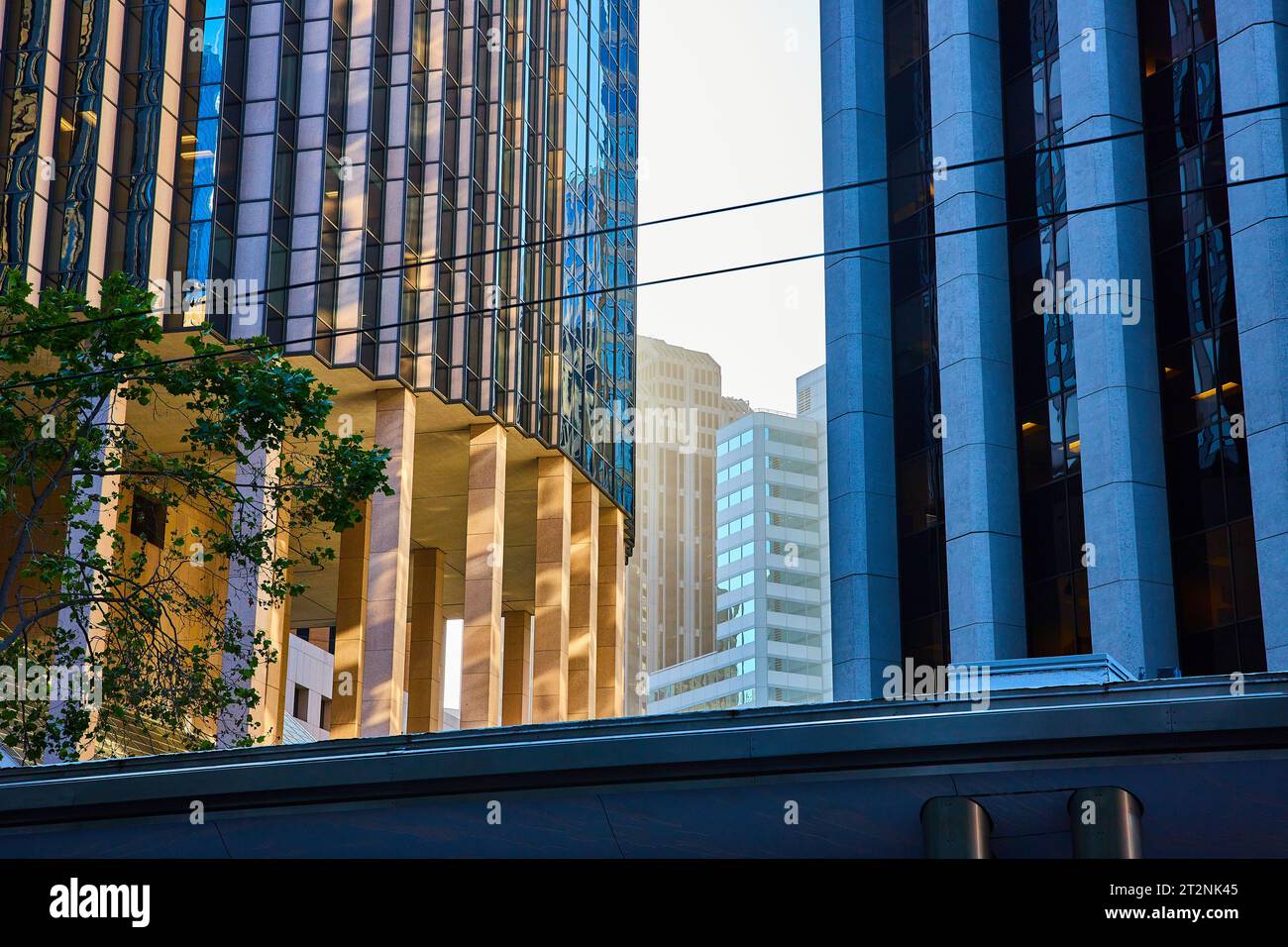 Two wires in front of large golden skyscraper in California with shaded ...