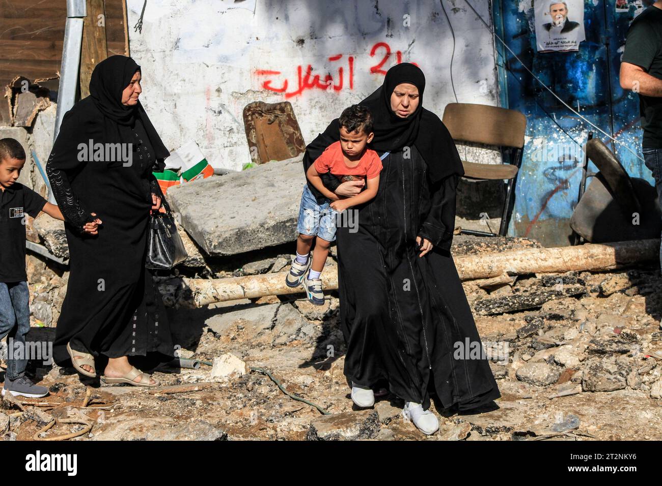 People look at destruction after an Israeli army raid on a Palestinian ...