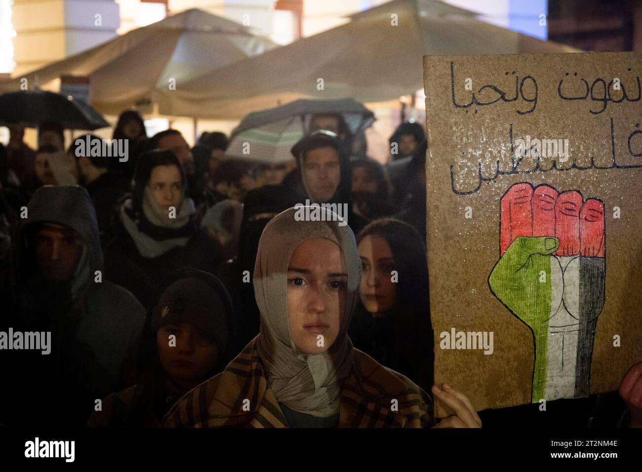 A young woman wearing a hijab is seen during a rally in support of ...