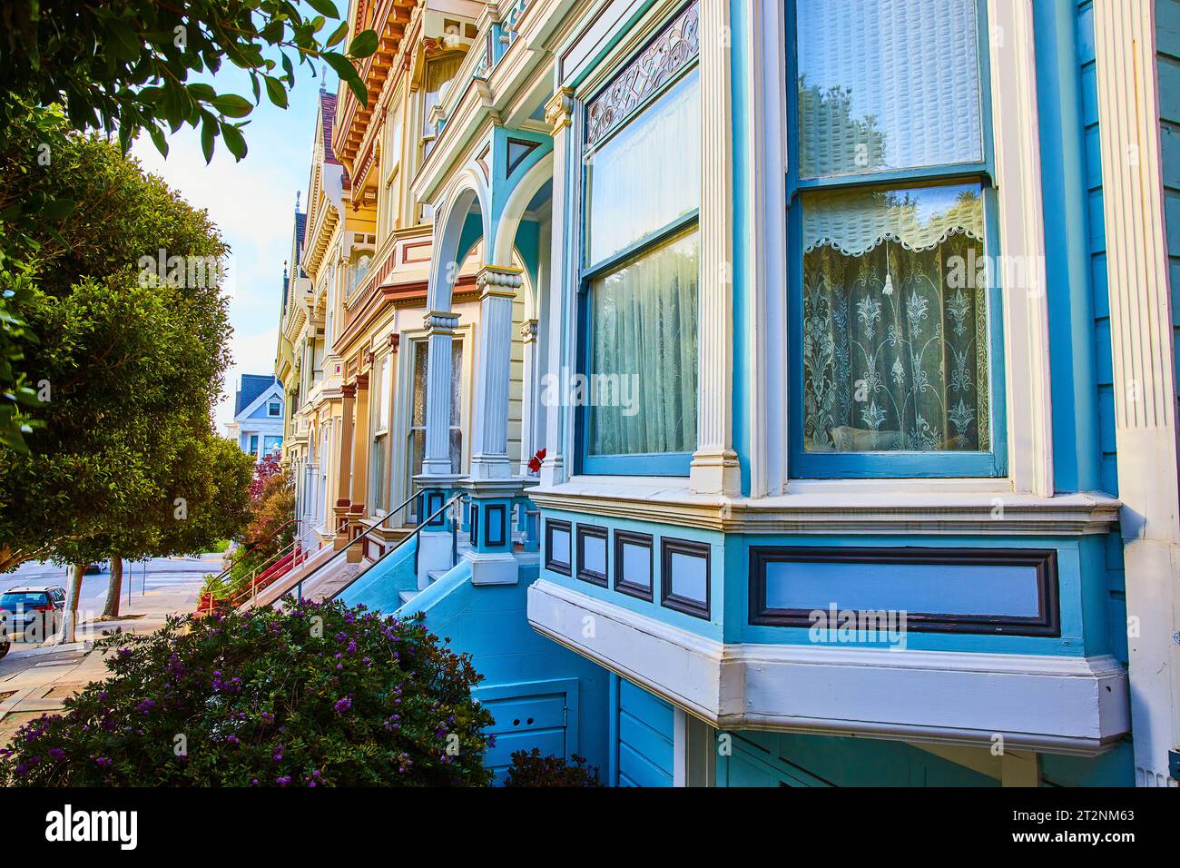 Front steps of The Painted Ladies with sky blue house having purple ...