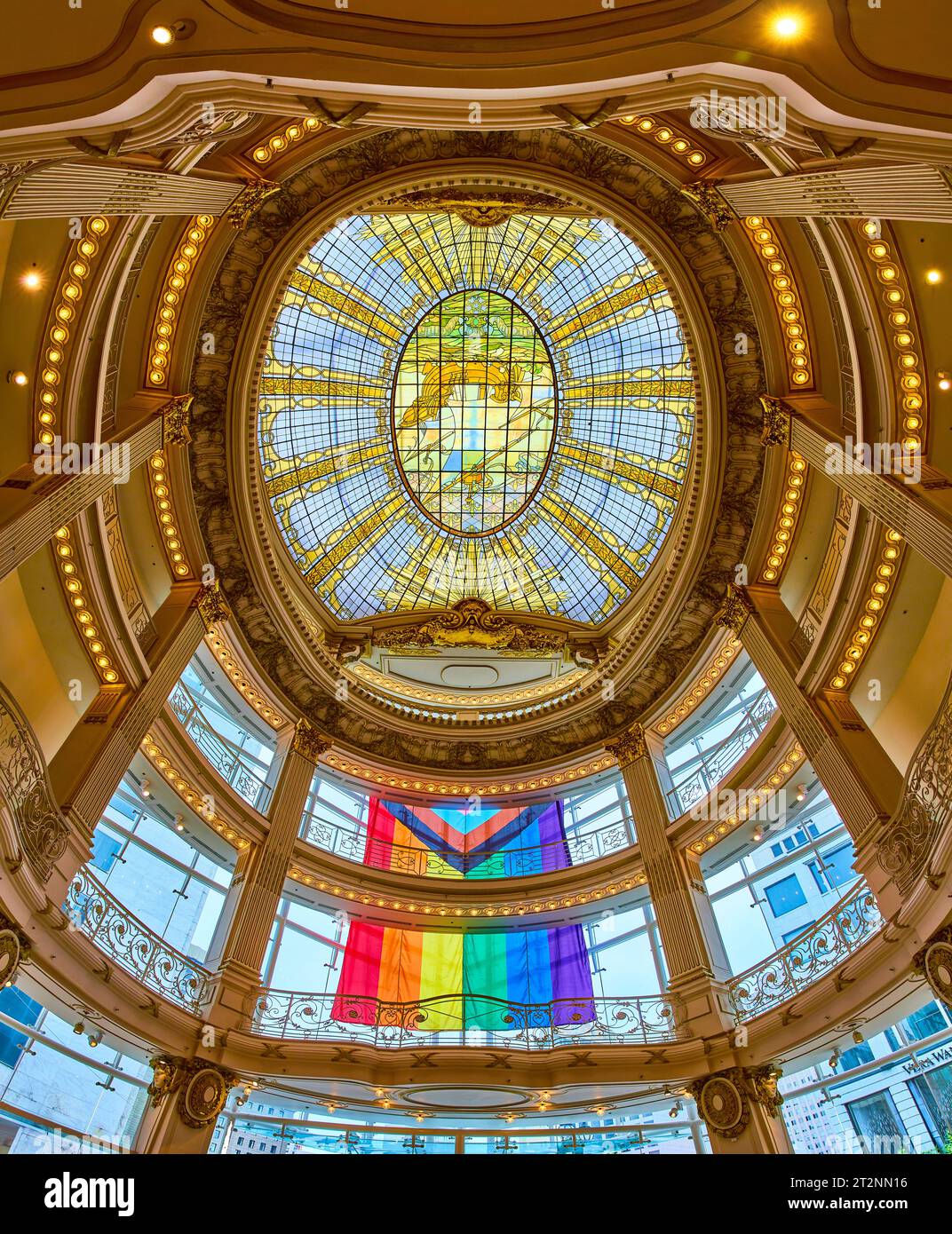 Giant pride flag on outside of window on domed golden building with ...
