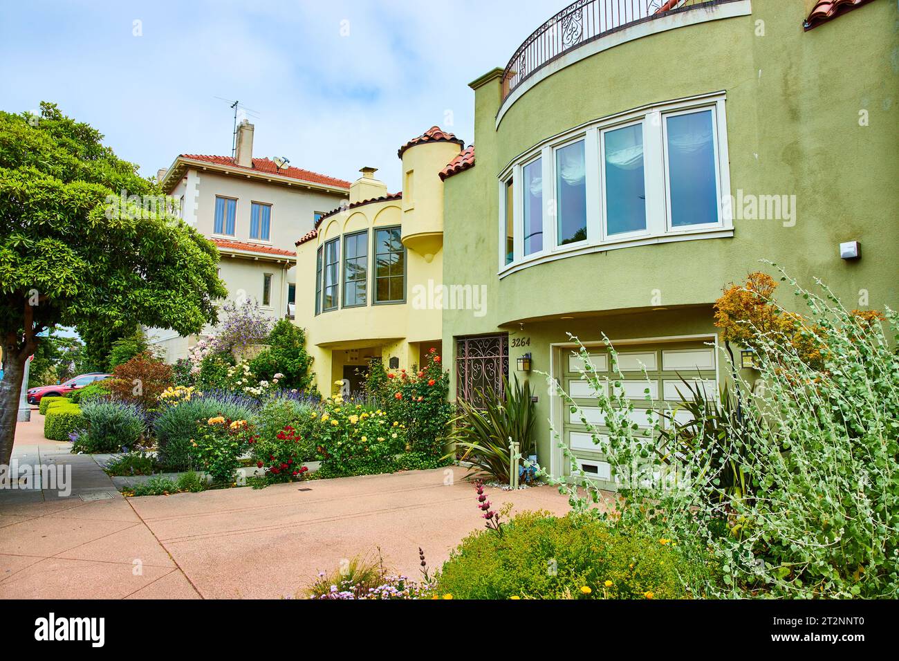 Houses with curved windows following smooth edge of building and flower ...