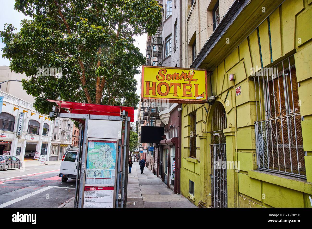 Sonny Hotel bright yellow sign with orange lettering on grimy building ...