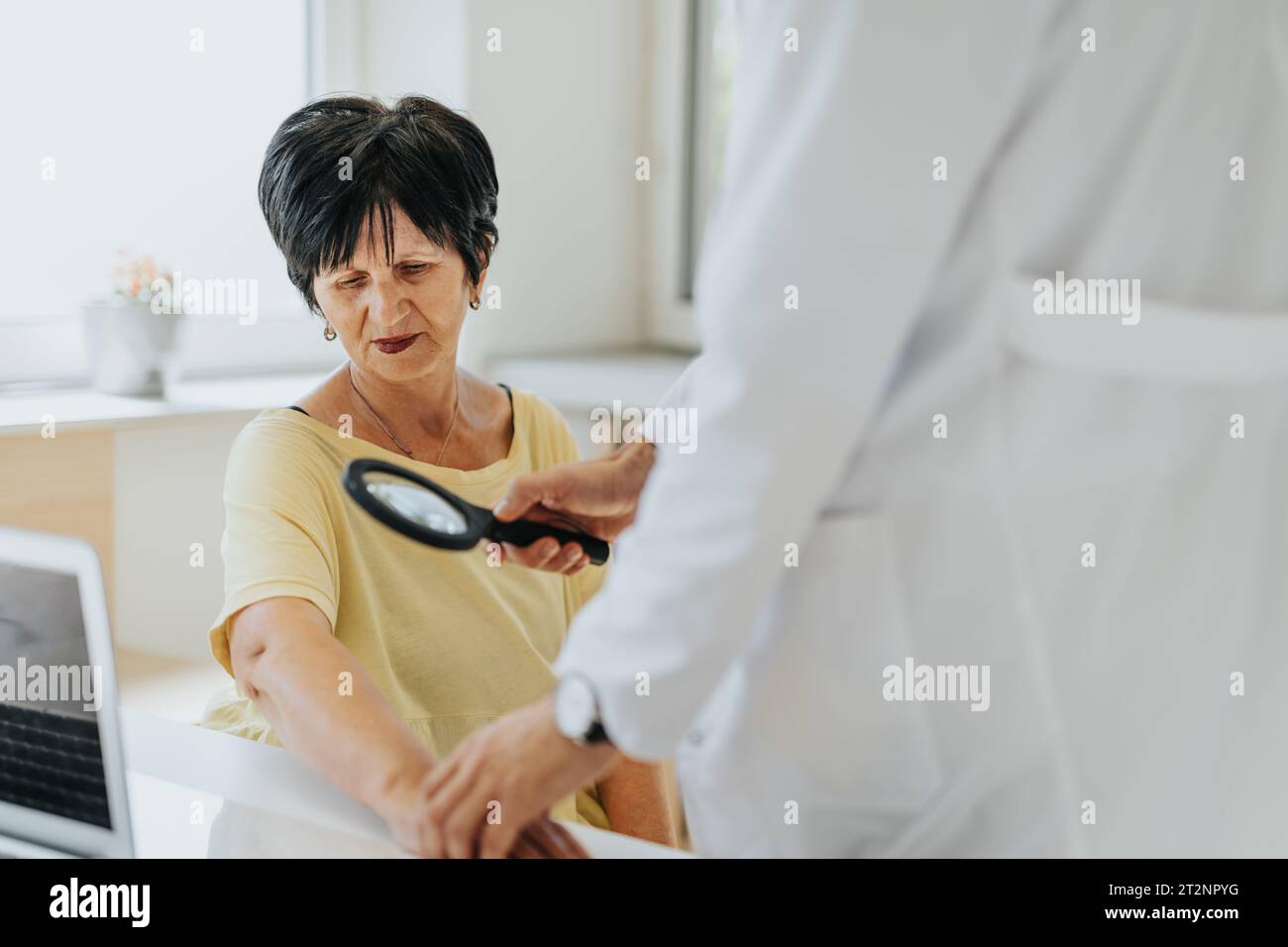 Partial, above view photo of doctor checking patient skin using ...