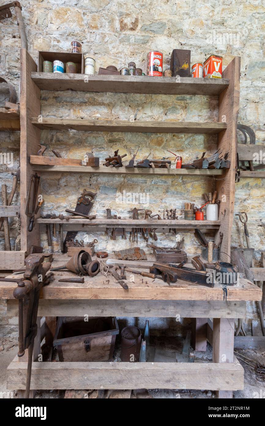 Photo of a selection of antique farm tools inside the barn atTyneham ...