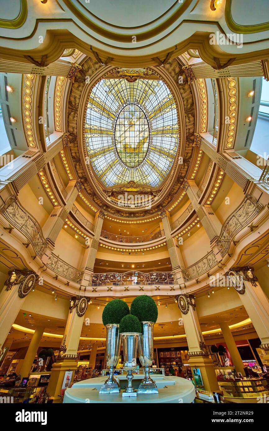 Fancy plant balls in lobby with balcony around middle and glass dome ...