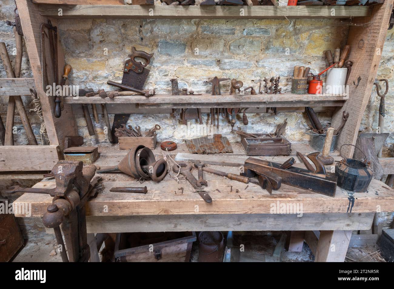 Photo of a selection of antique farm tools inside the barn atTyneham ...
