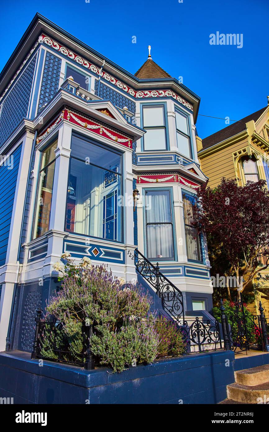 Front of blue The Painted Ladies house with glass entrance and fierce ...