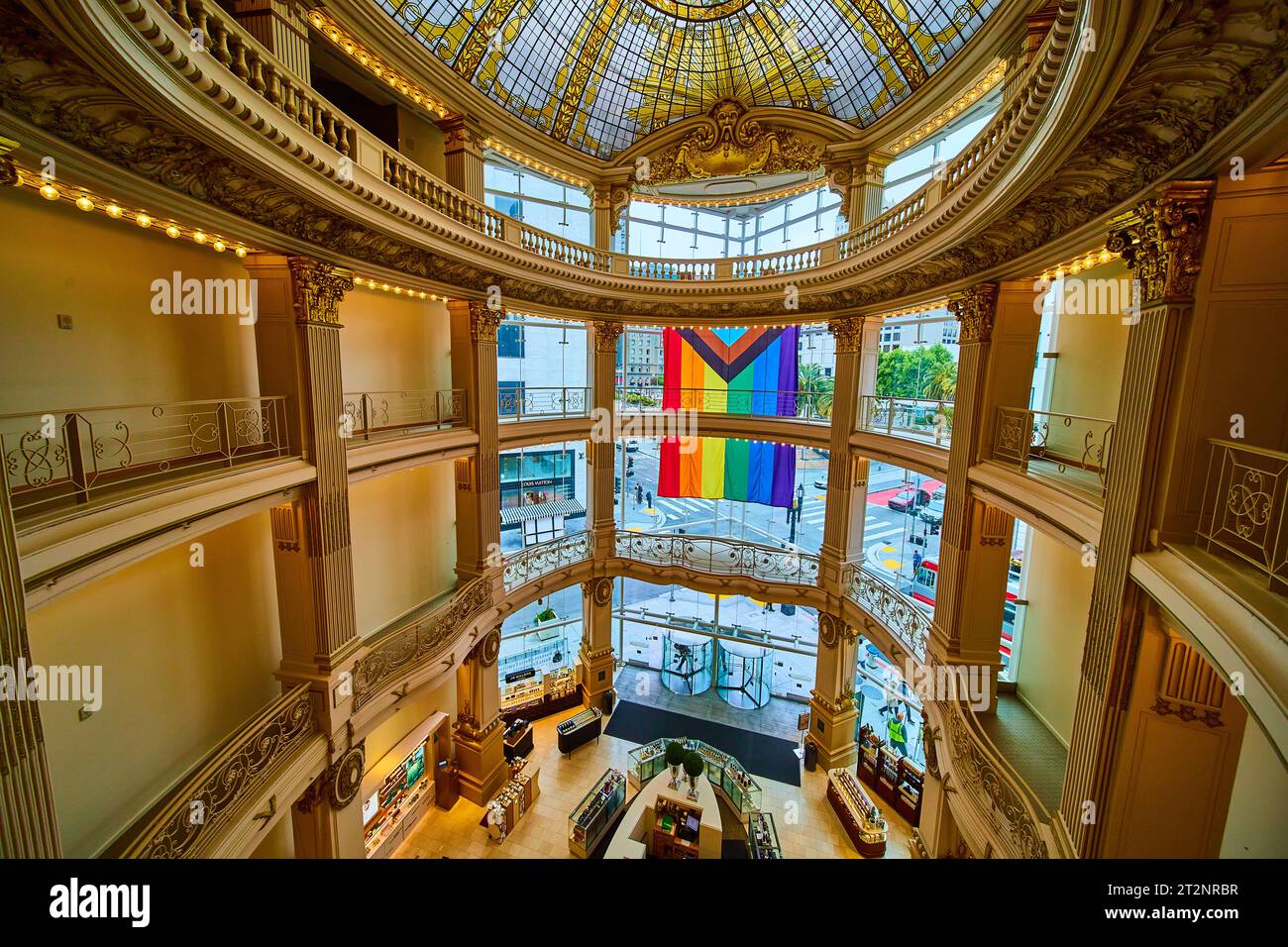 Pride flag on outside of window on domed golden building with stained ...