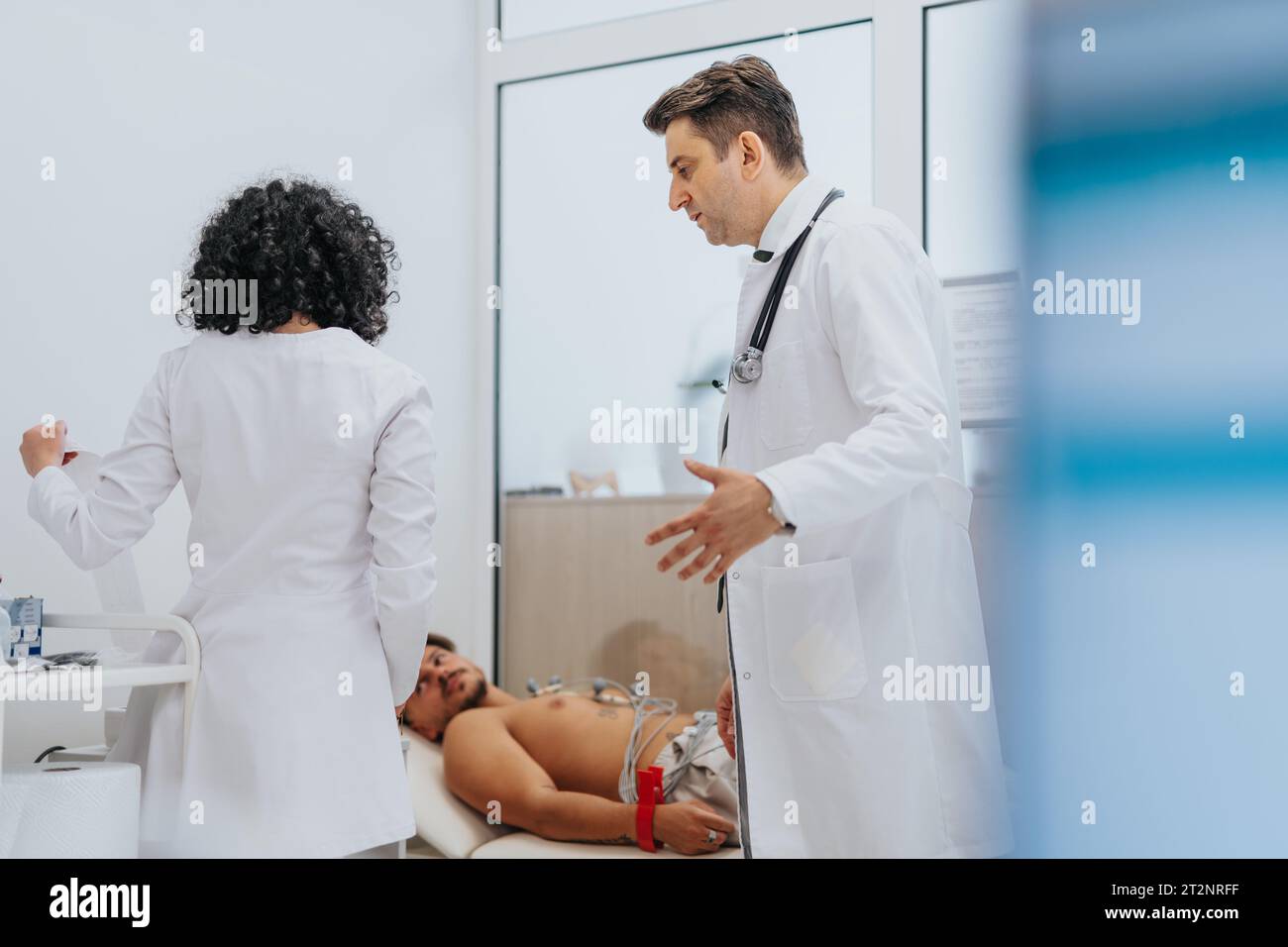 Experienced cardiologist analyzing ECG test results, advising on heart ...