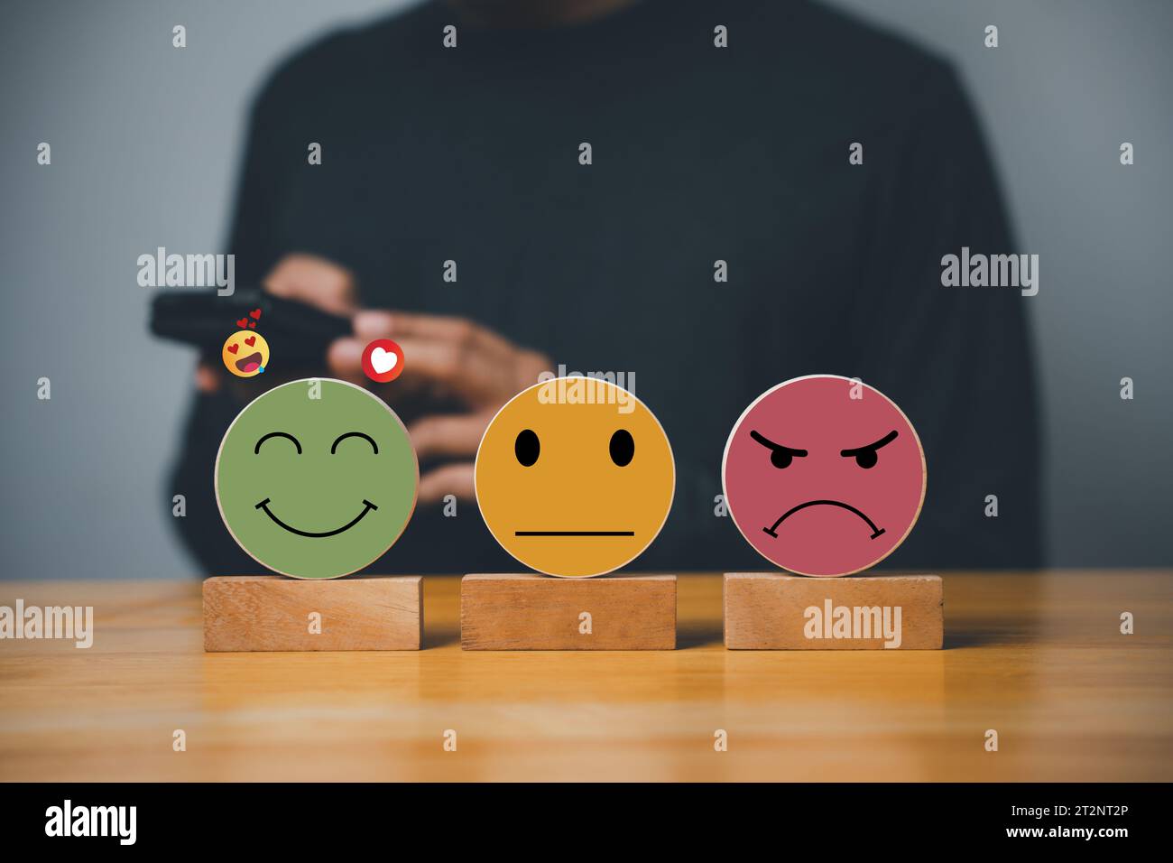 Selecting a smiley face on a wooden block circle Stock Photo - Alamy