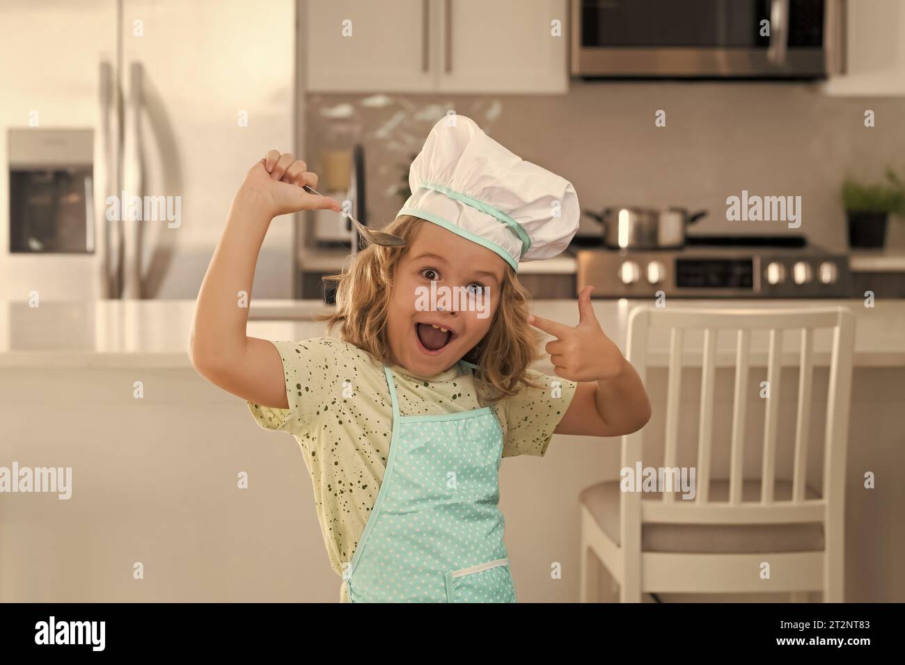 Child chef cook prepares food at kitchen. Kids cooking. Teen boy with ...