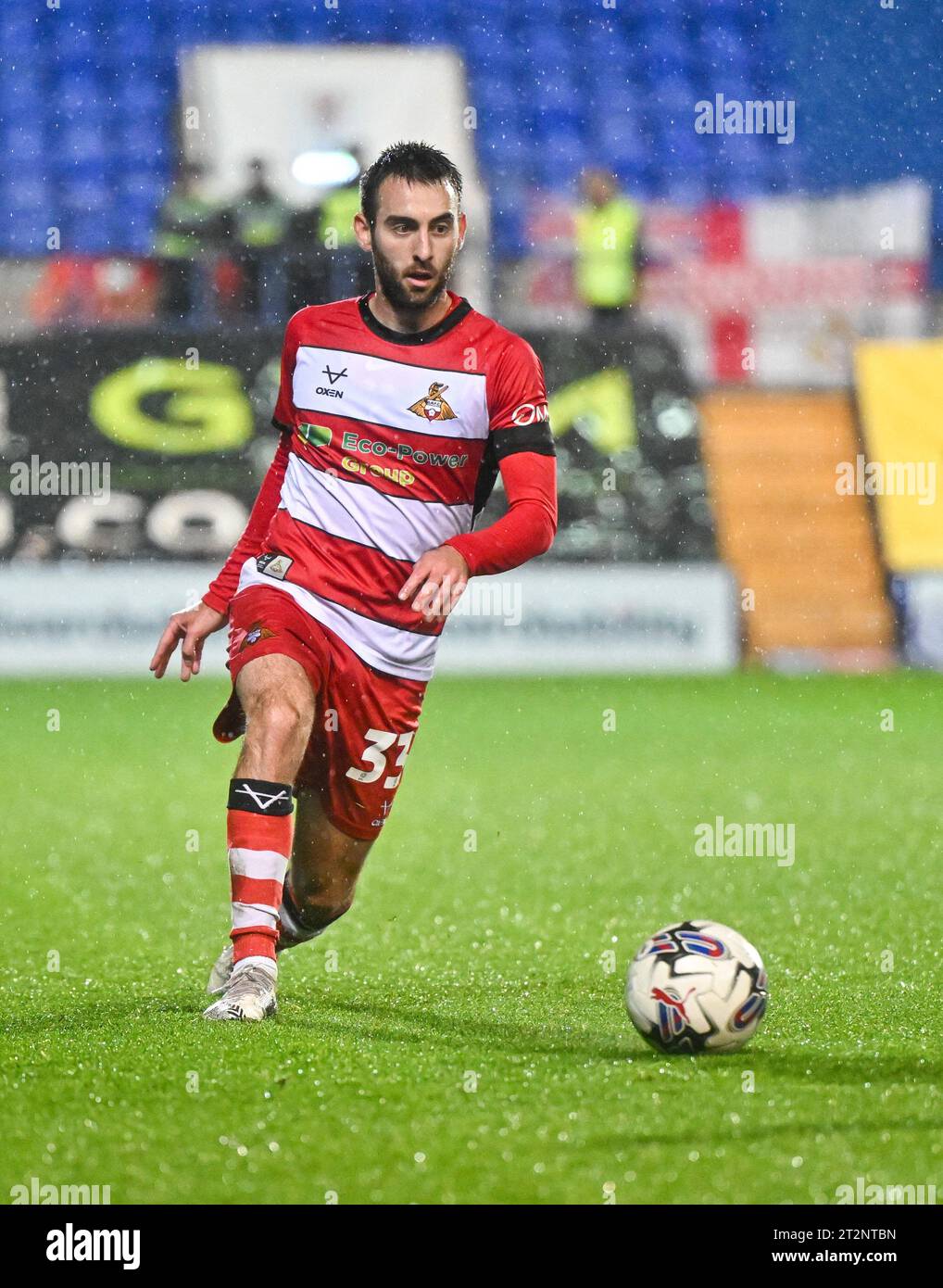 Ben Close 33# of Doncaster Rovers Football Club passes the ball, during ...