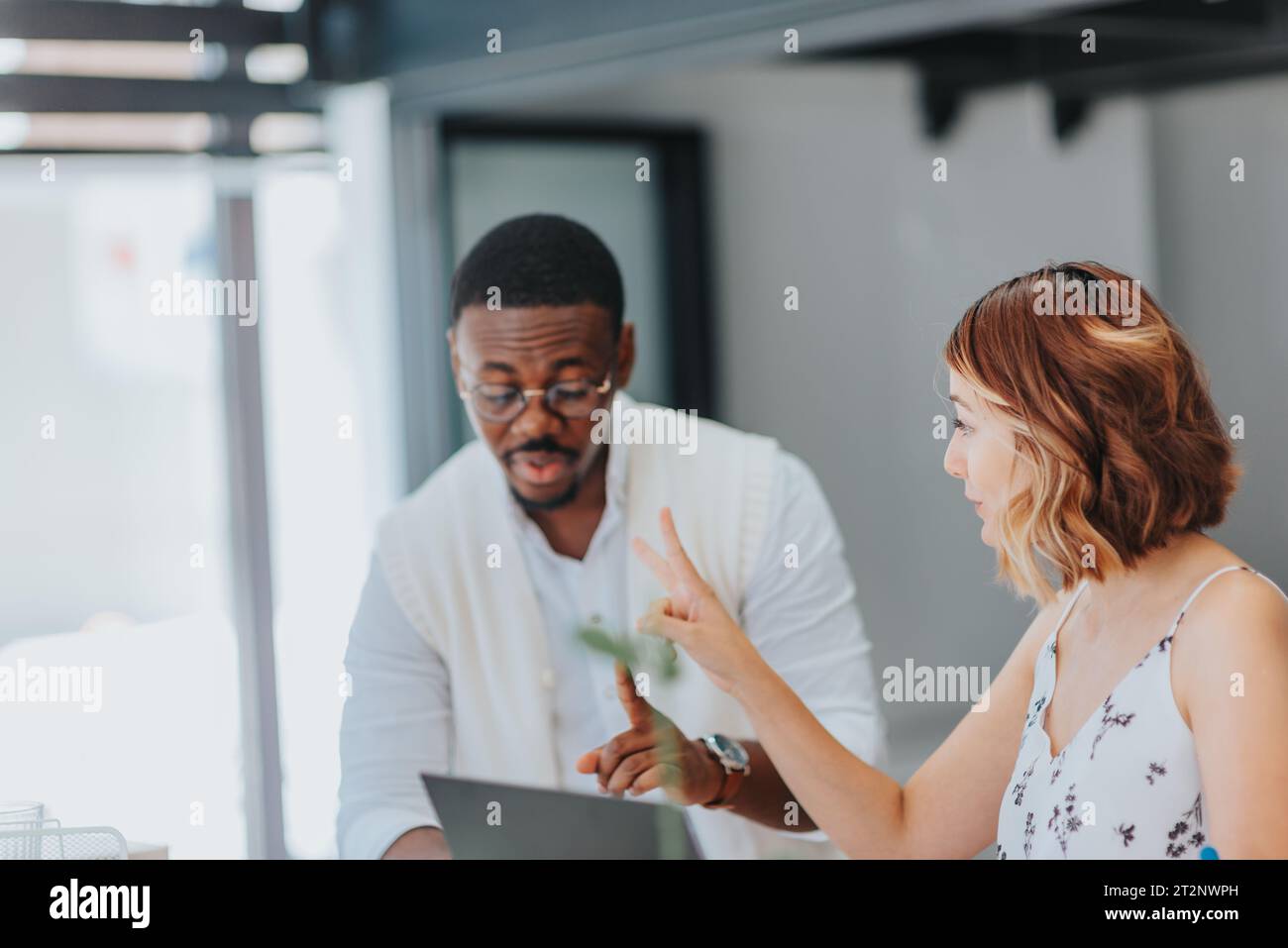 In a modern office, a diverse business partners collaborates on content ...