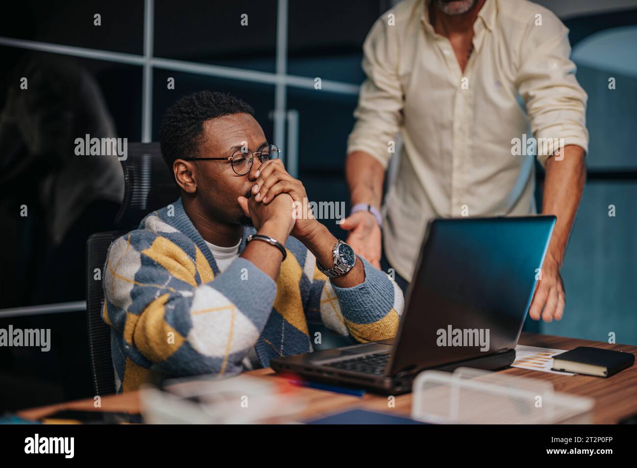 People collaborate in a boardroom, discussing sales, statistics and ...