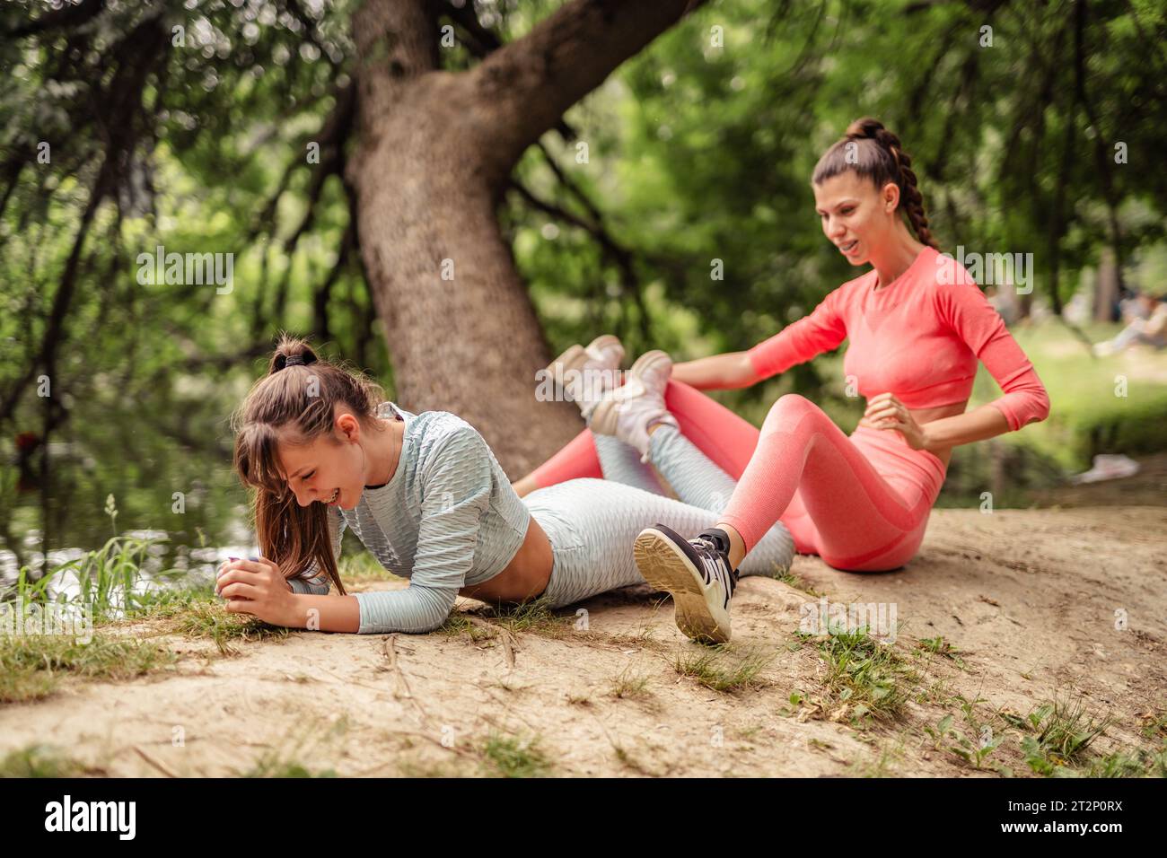 Active Female Friends Training Together in Urban Park Stock Photo - Alamy