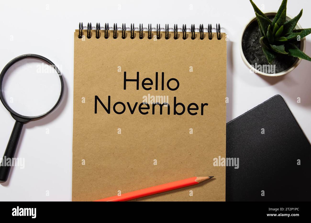 Hello November. hand drawn lettering on notepad at the table with ...