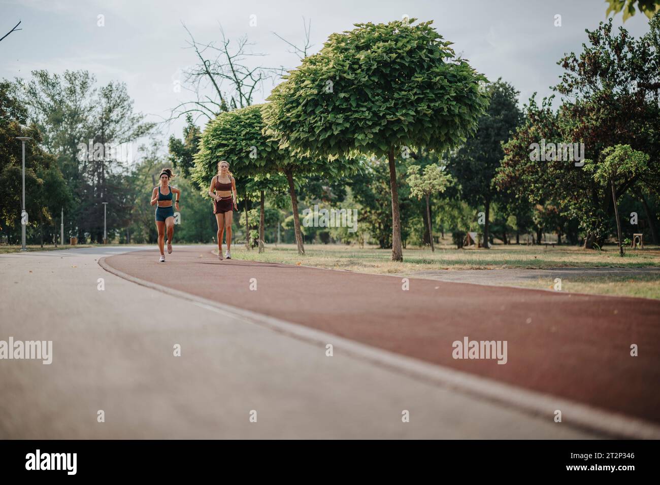 Fit girls jogging in nature, inspiring workout outdoors. Attractive ...