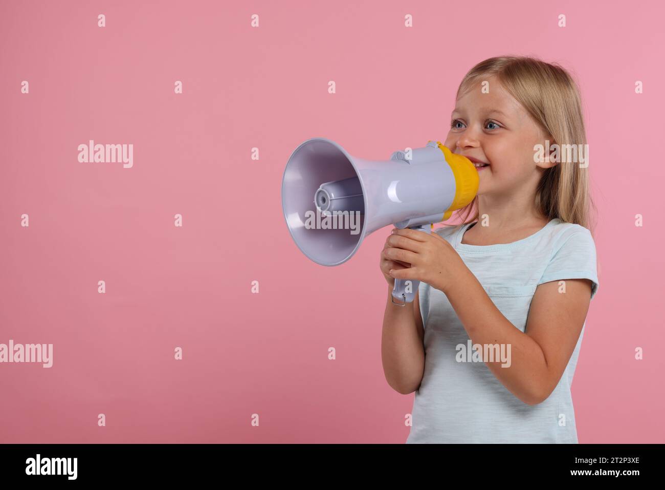 Special promotion. Little girl with megaphone on pink background. Space ...