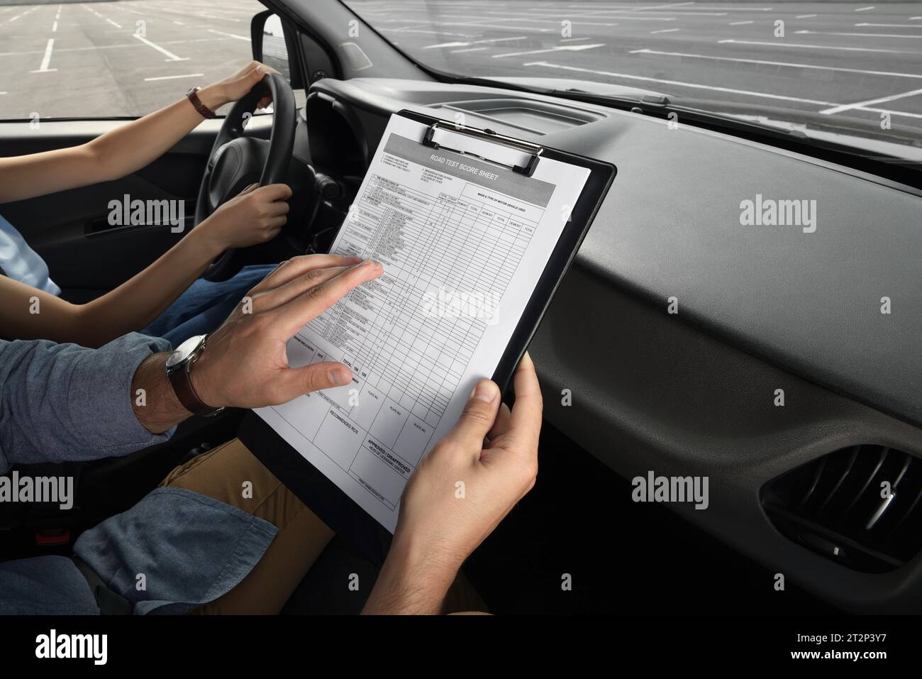 Driving school. Student passing driving test with examiner in car at ...