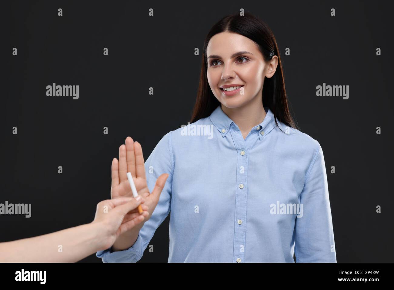 Stop smoking concept. Woman refusing cigarette on black background ...